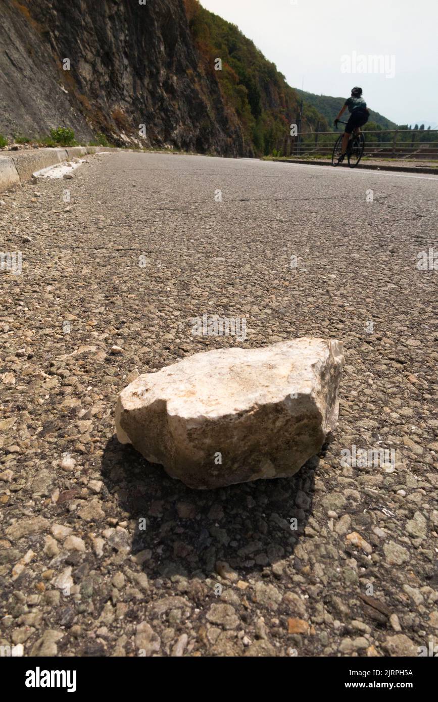 Fallen rock / cliff rocks on the road cause a hazard to car, drivers ...