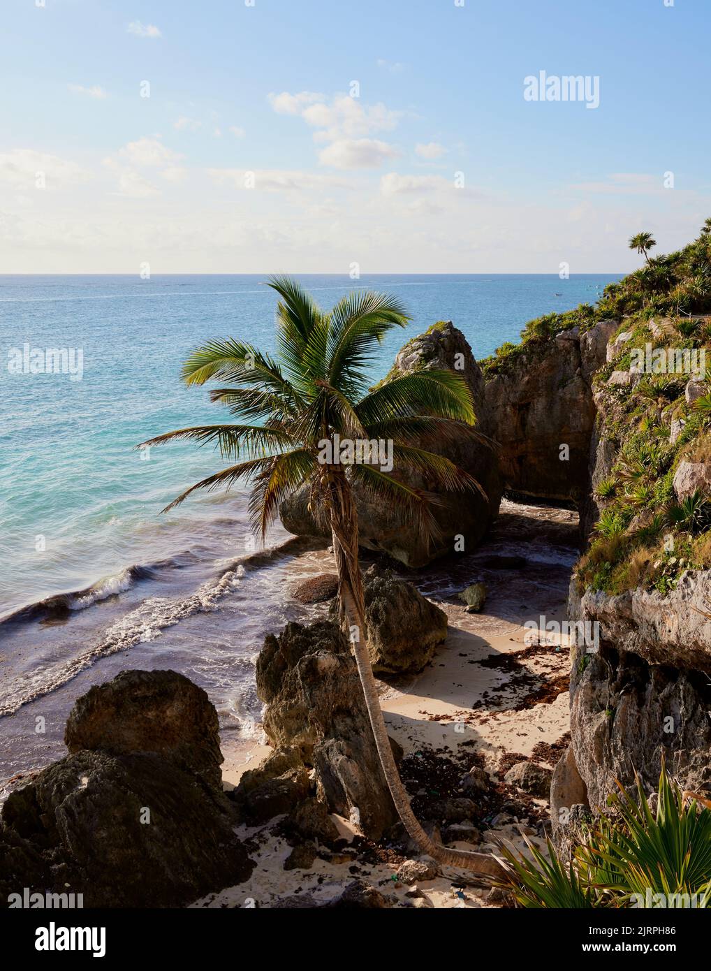 A vertical shot of the Tulum ruins near the turquoise ocean in Mexico ...