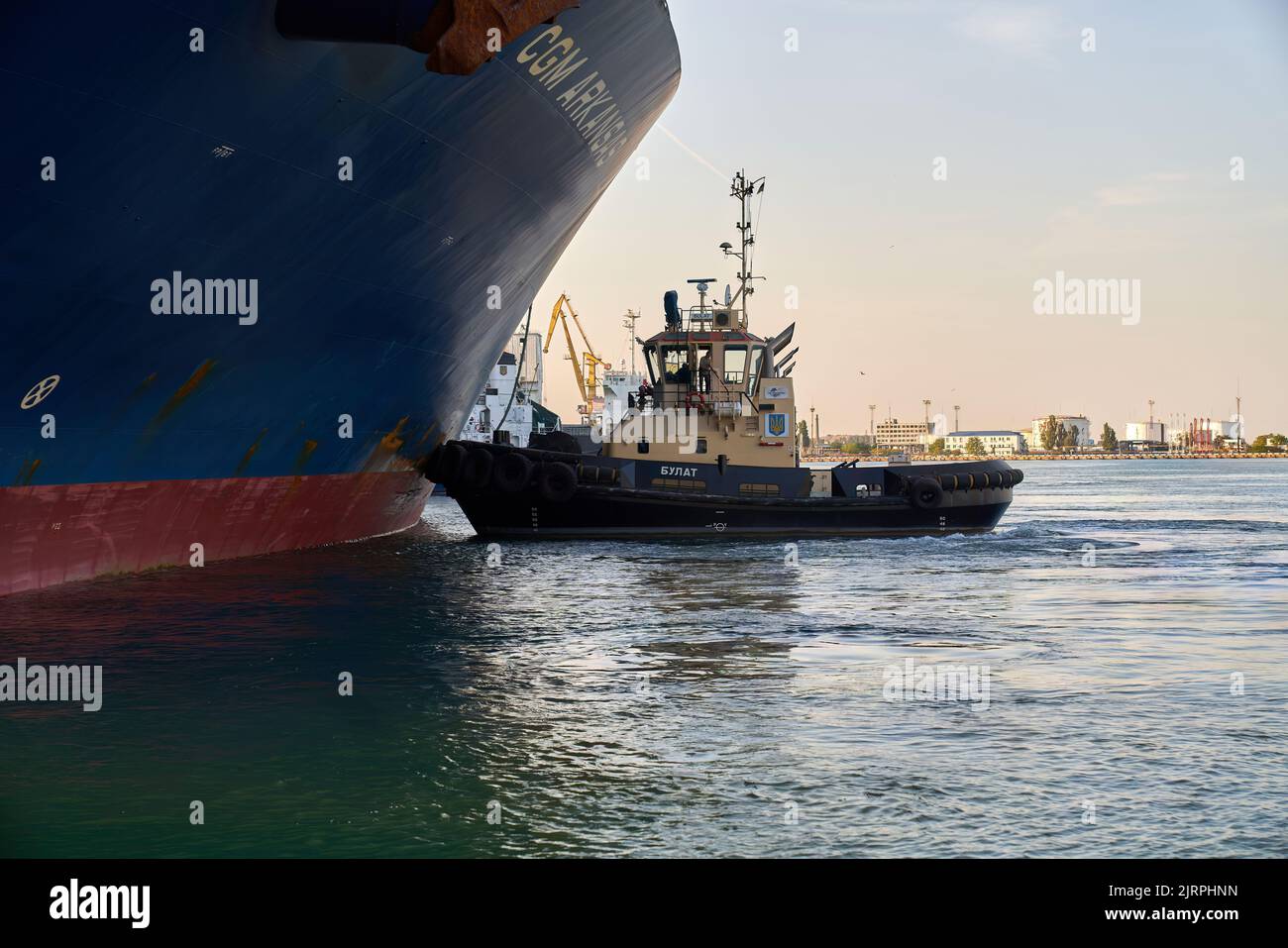Odessa, Ukraine SIRCA 2019: A tugboat pushes container ship at port ...