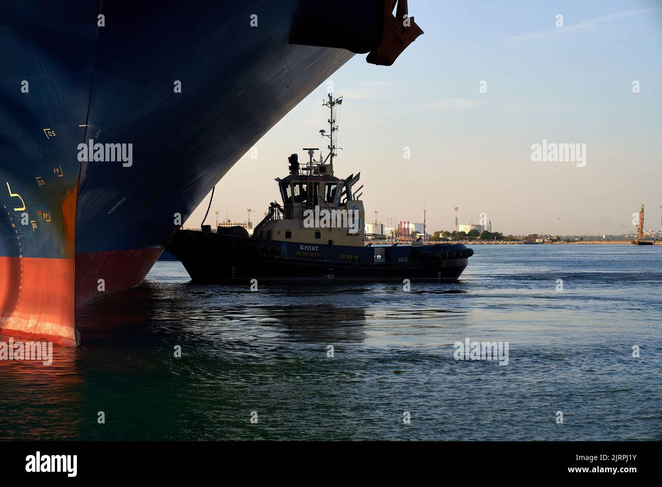 Odessa, Ukraine SIRCA 2019: A tugboat pushes container ship at port ...