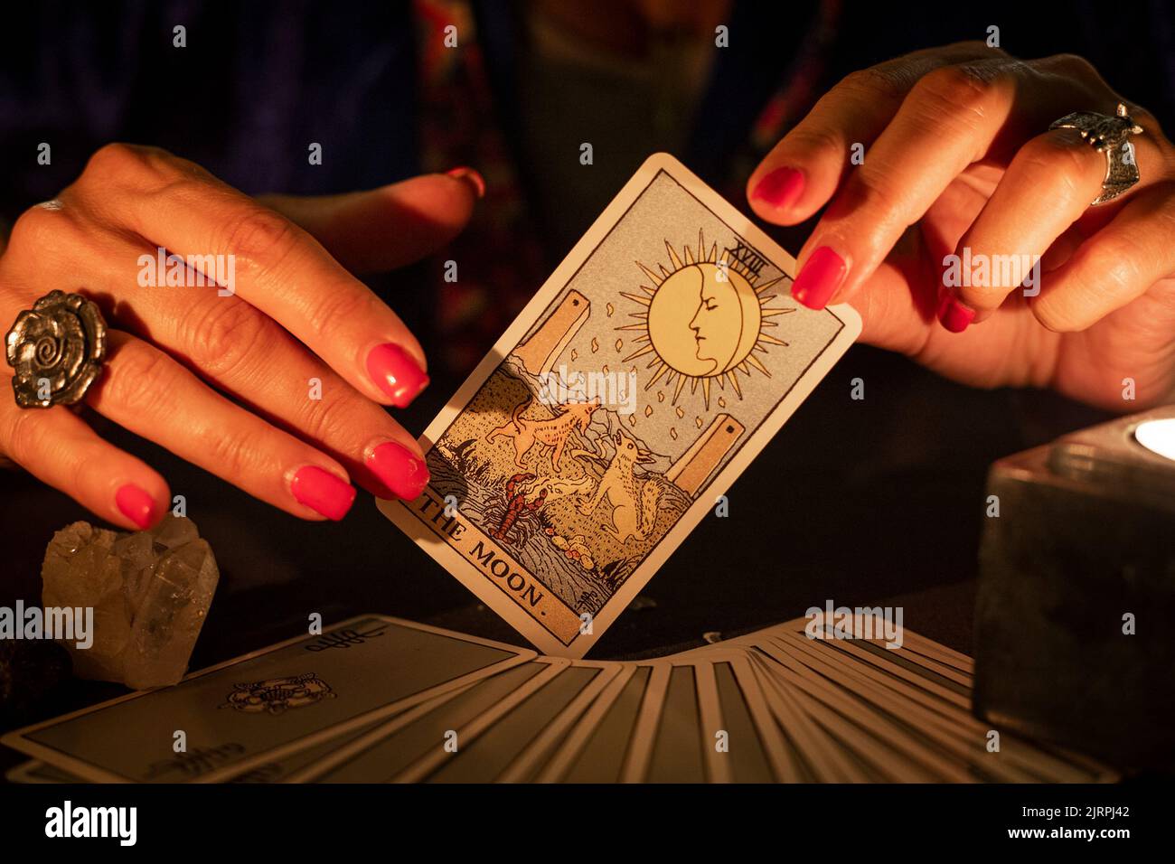 Fortune teller hands showing The Moon tarot card, symbol of intuition ...