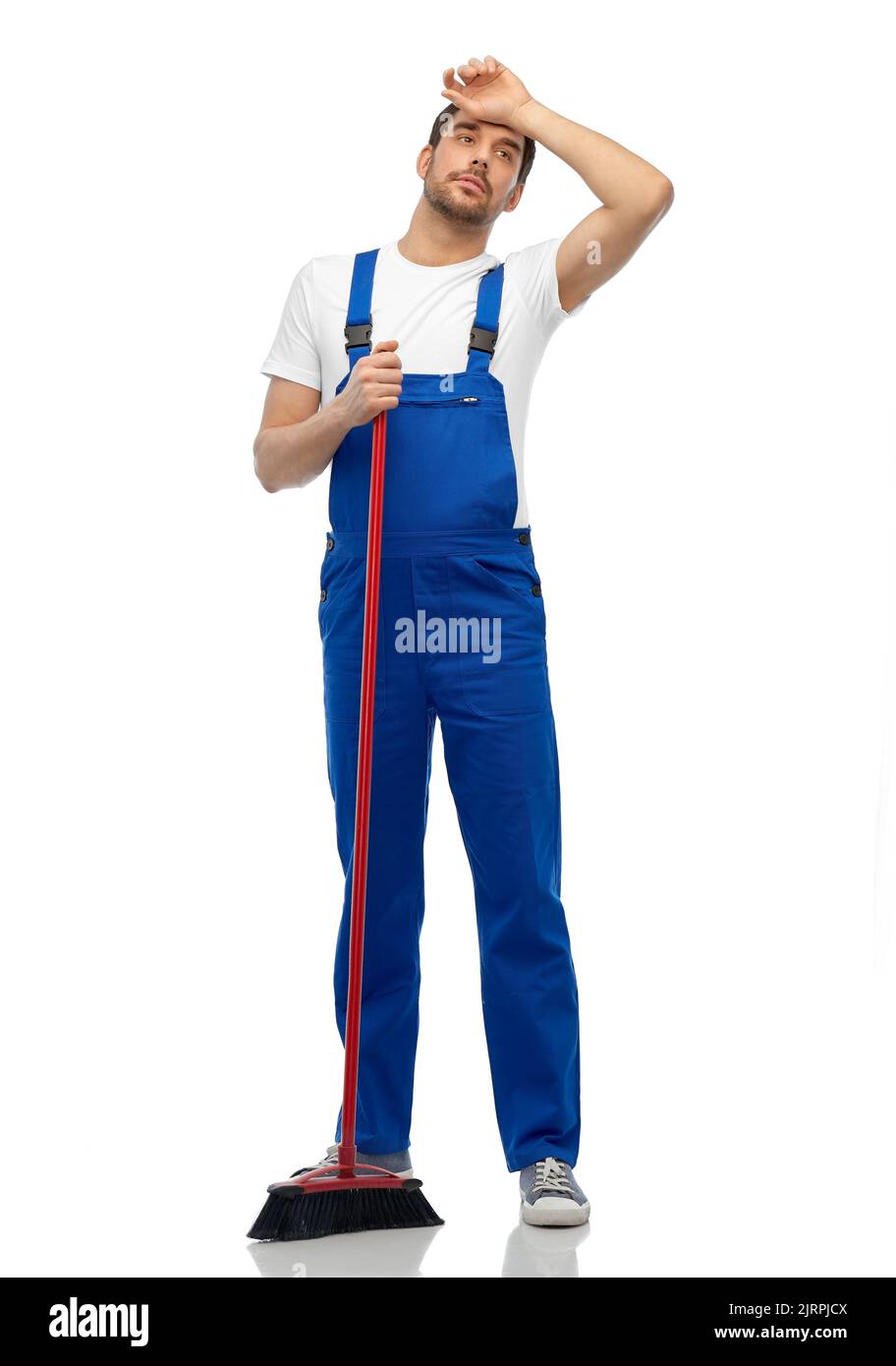 tired male cleaner cleaning floor with broom Stock Photo - Alamy