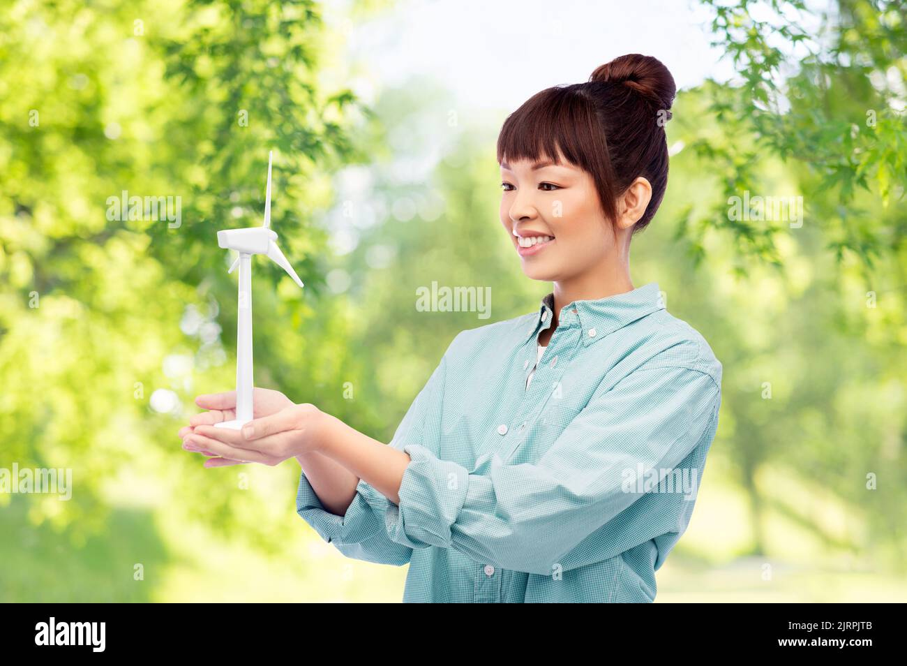 smiling young asian woman with toy wind turbine Stock Photo - Alamy