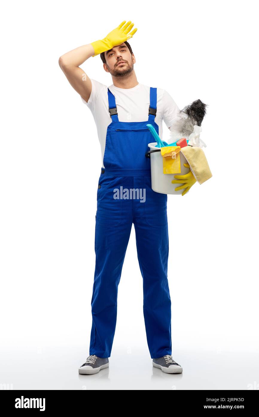 tired male cleaner with cleaning supplies Stock Photo - Alamy