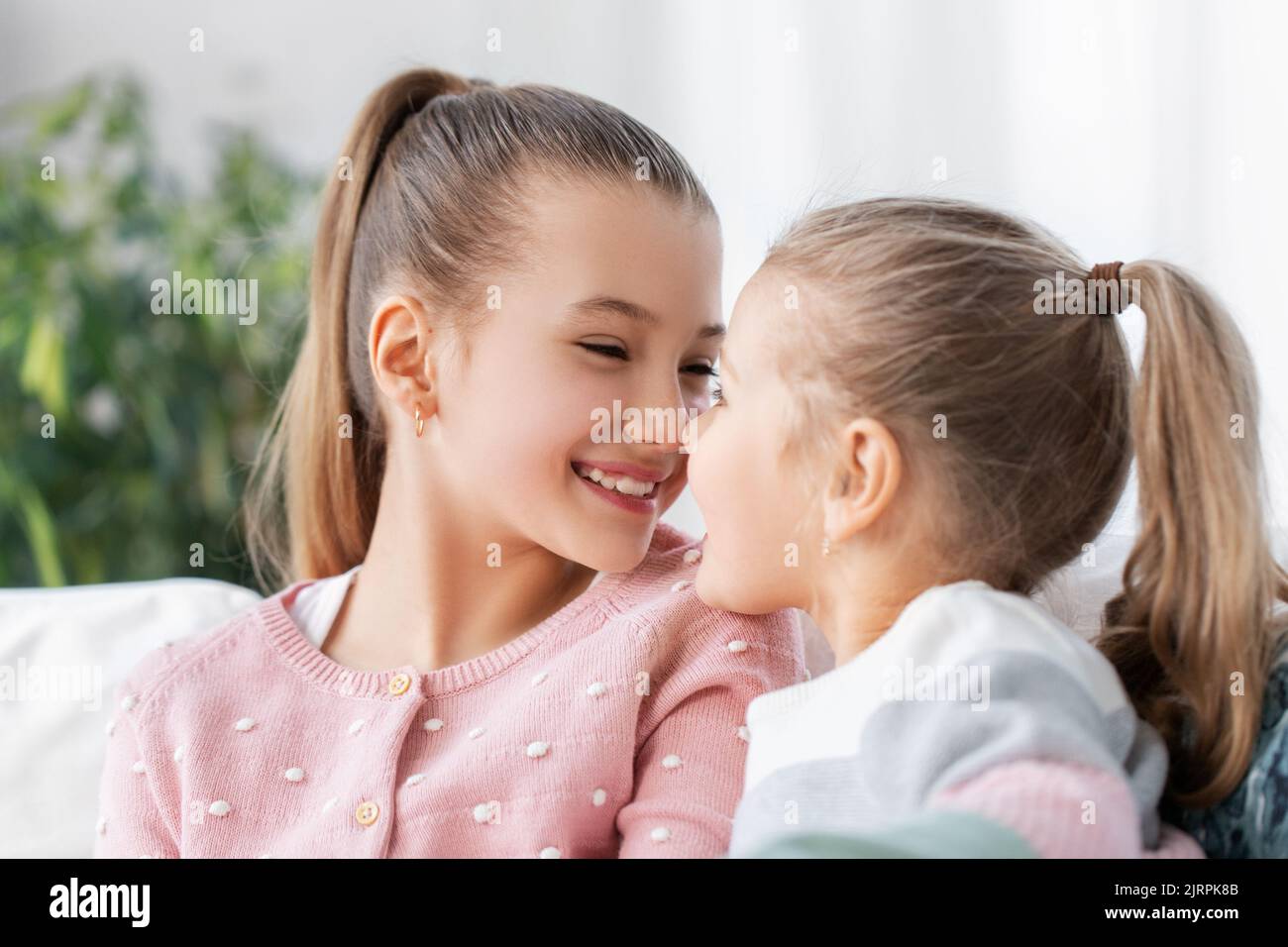 two happy smiling little girls or sisters at home Stock Photo - Alamy