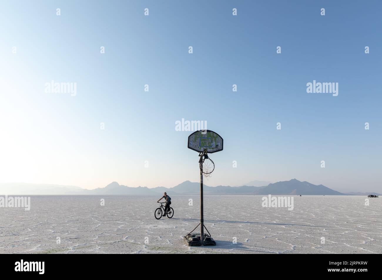 Young woman riding a bike on Bonneville Salt Flats in Utah Stock Photo ...