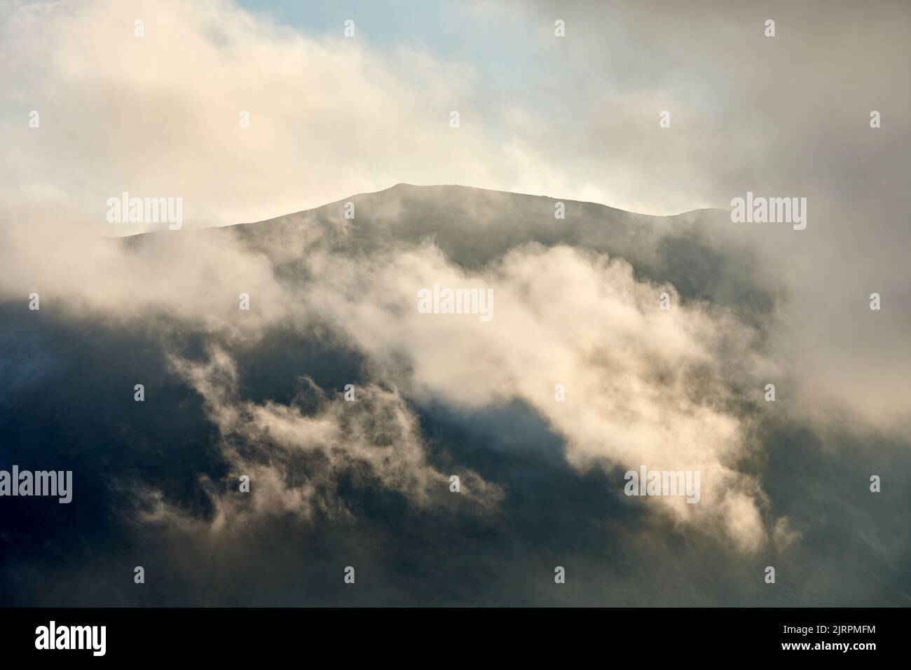 White clouds floating over volcanic mountainous terrain Stock Photo - Alamy