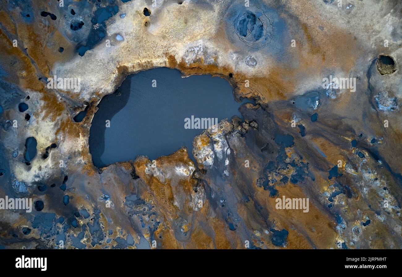 Mud pool surrounded with geothermal fissures Stock Photo - Alamy