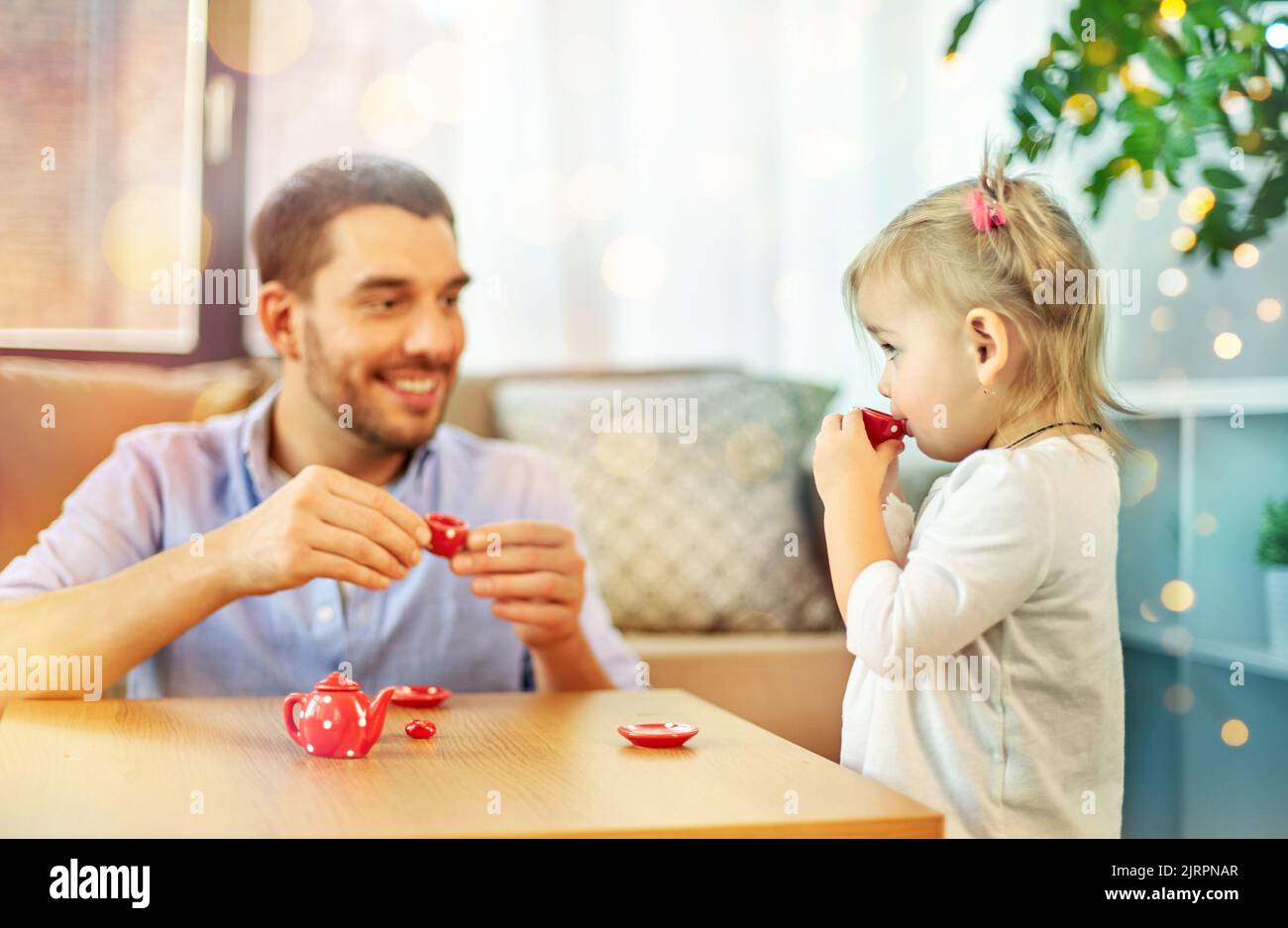 father and daughter playing tea party at home Stock Photo - Alamy