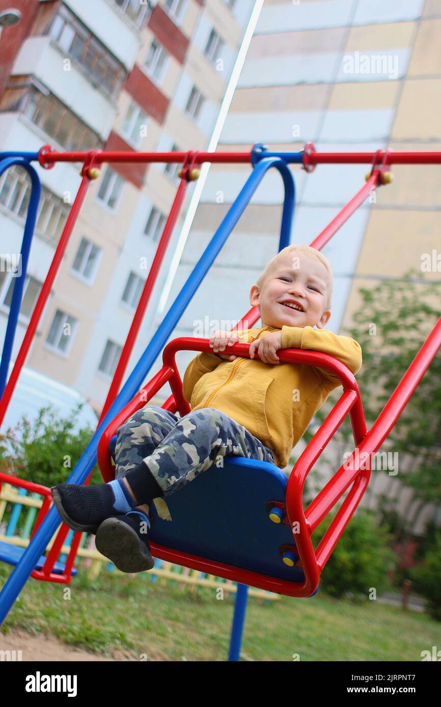 Baby on swings hi-res stock photography and images - Alamy
