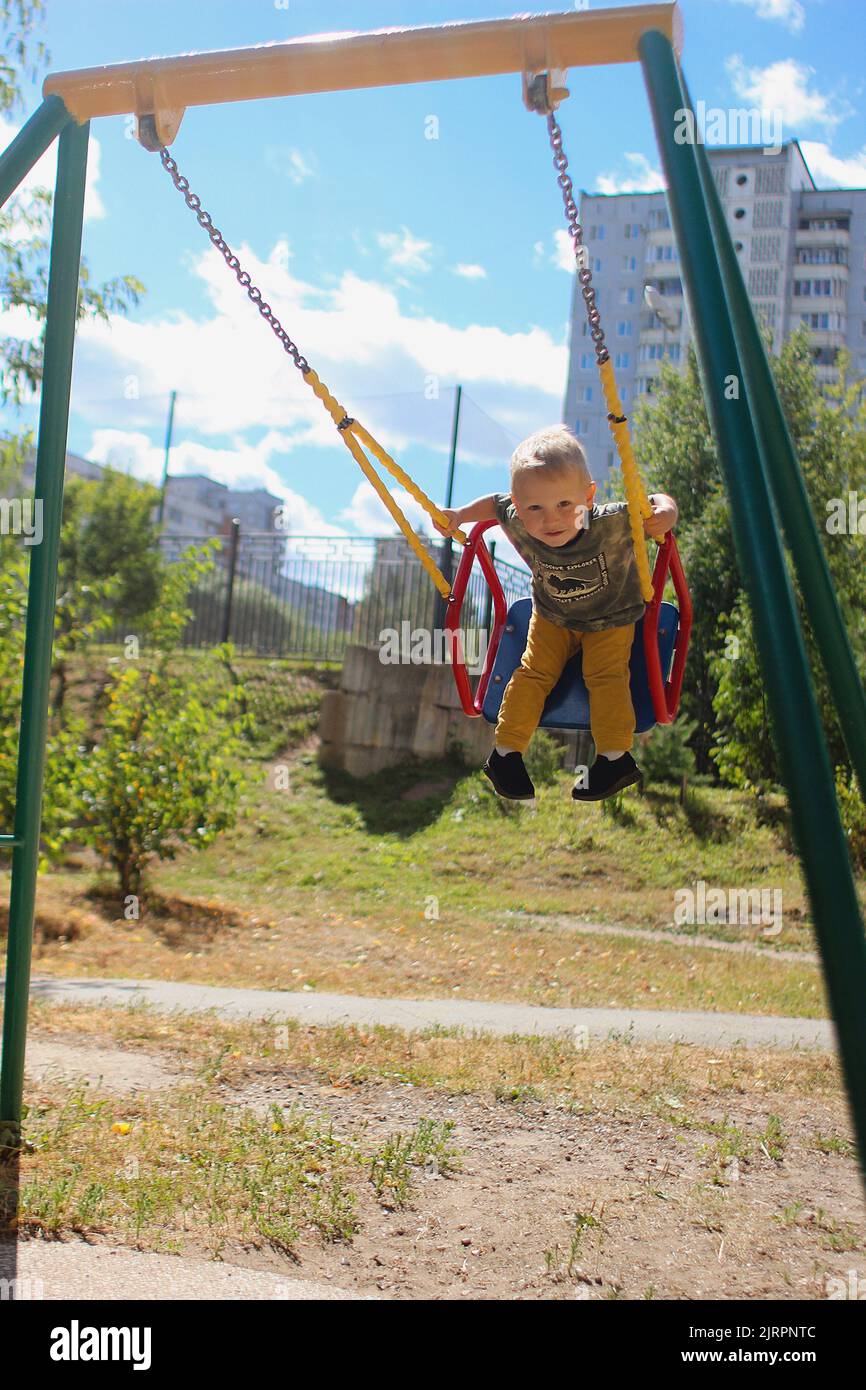 Red baby swing hi-res stock photography and images - Alamy
