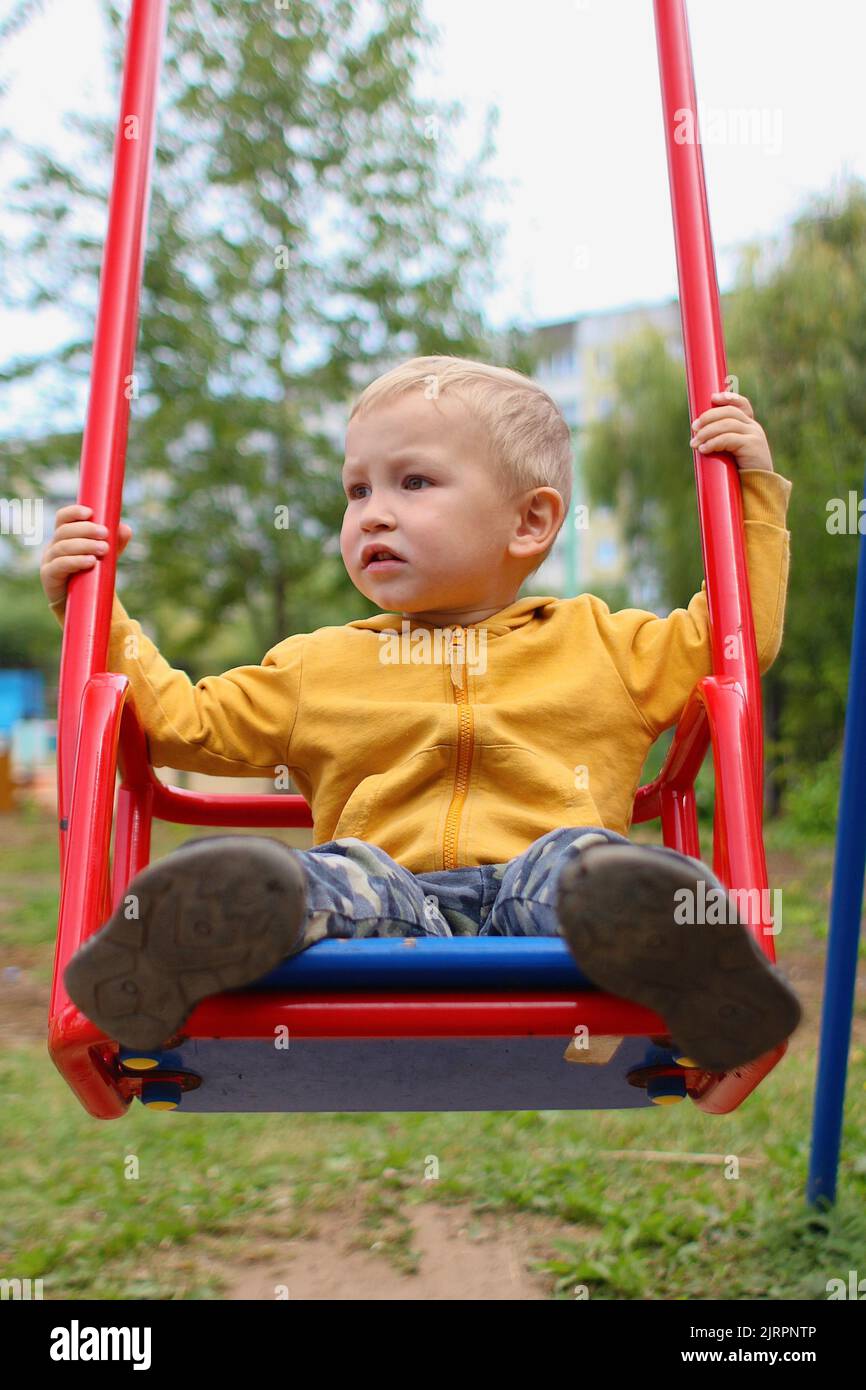 Red swings hi-res stock photography and images - Alamy