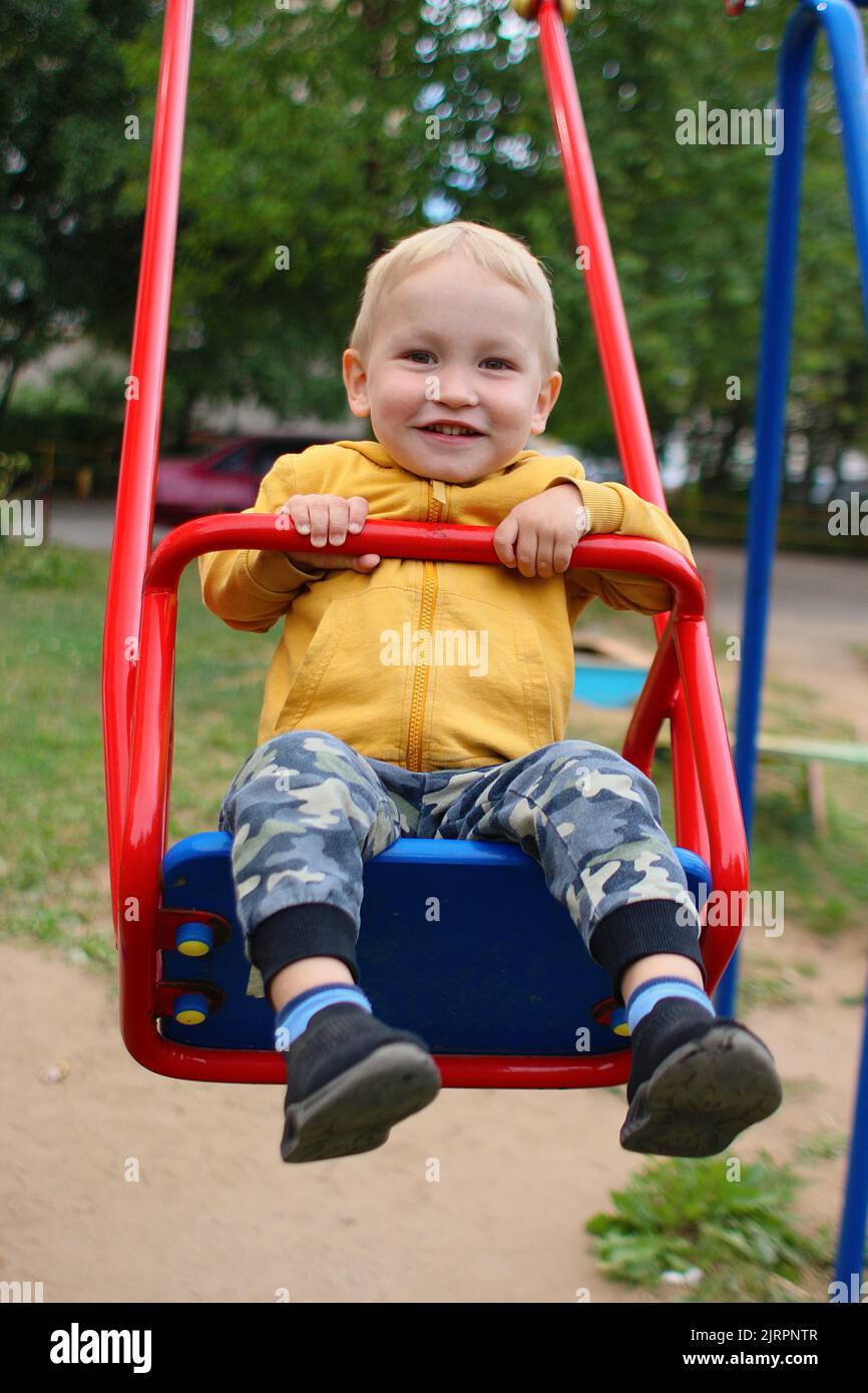 Swings boy hi-res stock photography and images - Alamy