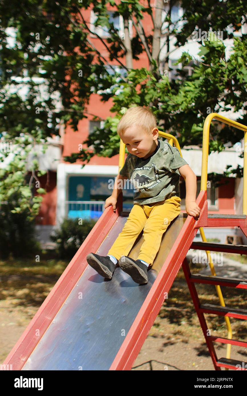Boy on slide hi-res stock photography and images - Alamy