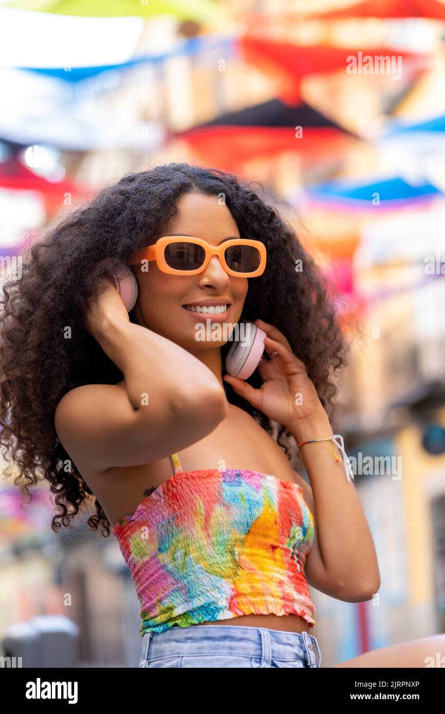 girl with afro hair listening to music with her headphones Stock Photo ...