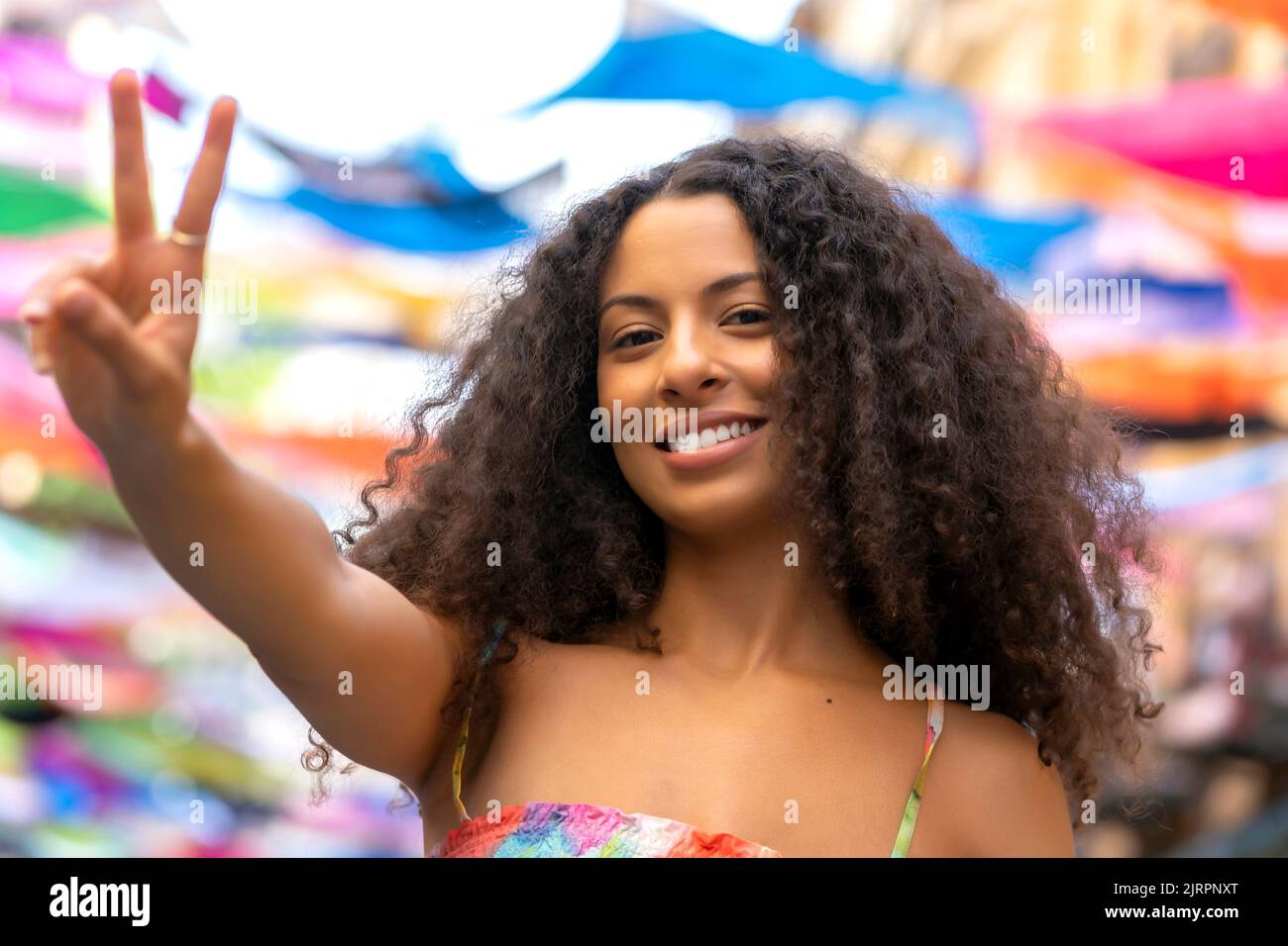 girl with afro hair doing the peace sign Stock Photo - Alamy