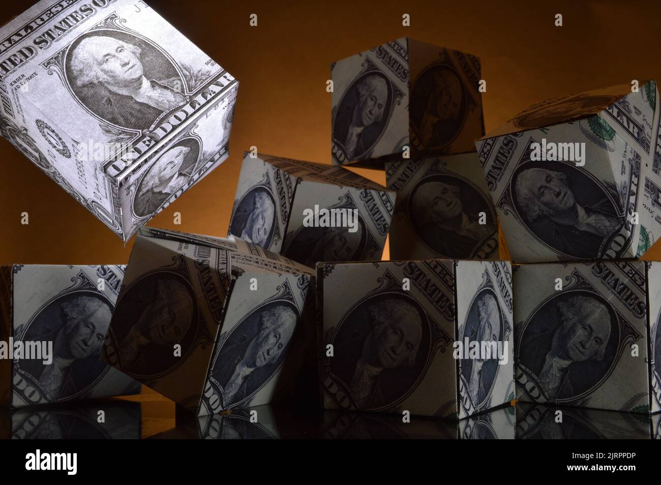 Glowing dollar bills folded into cubes Stock Photo - Alamy