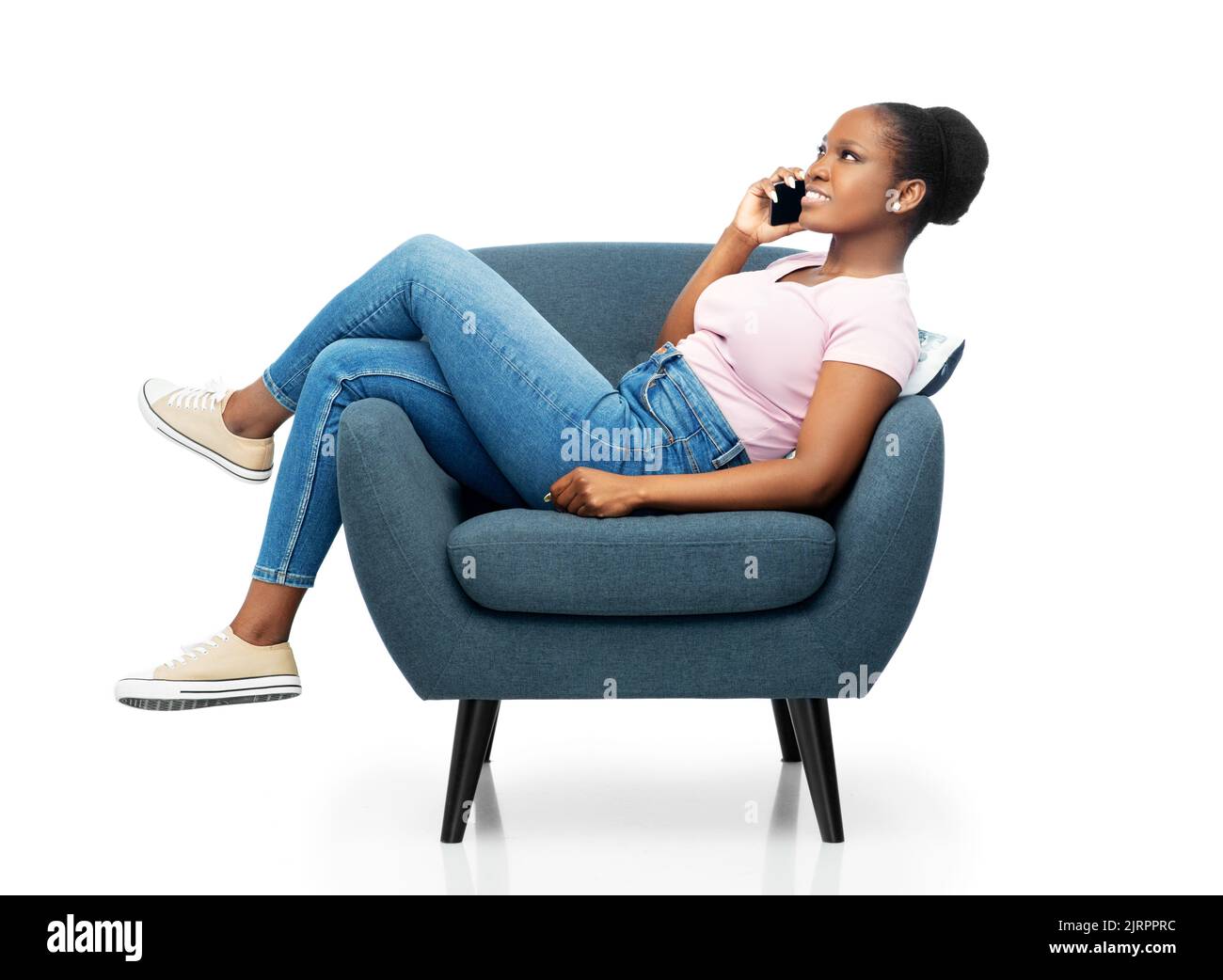 african woman calling on smartphone in armchair Stock Photo - Alamy