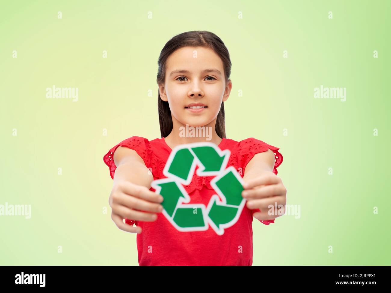 smiling girl holding green recycling sign Stock Photo - Alamy