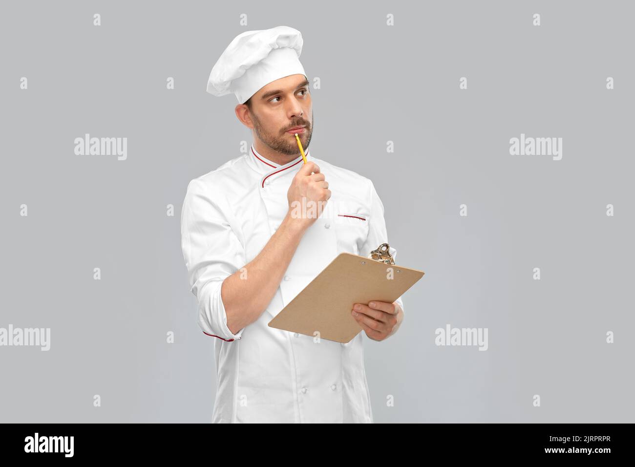 thinking male chef with clipboard Stock Photo - Alamy