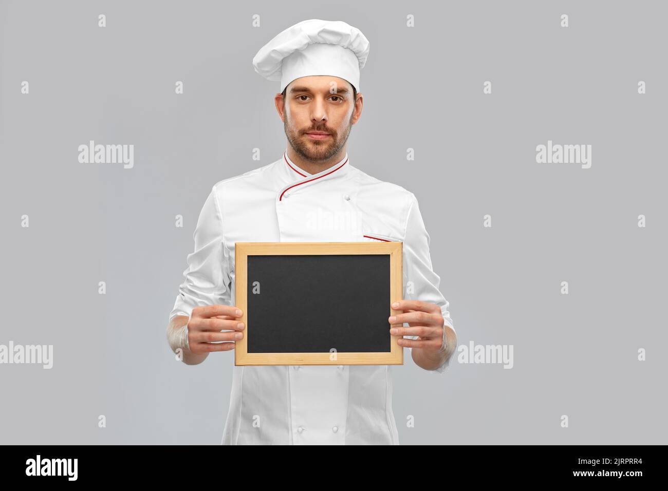 male chef showing chalkboard Stock Photo - Alamy