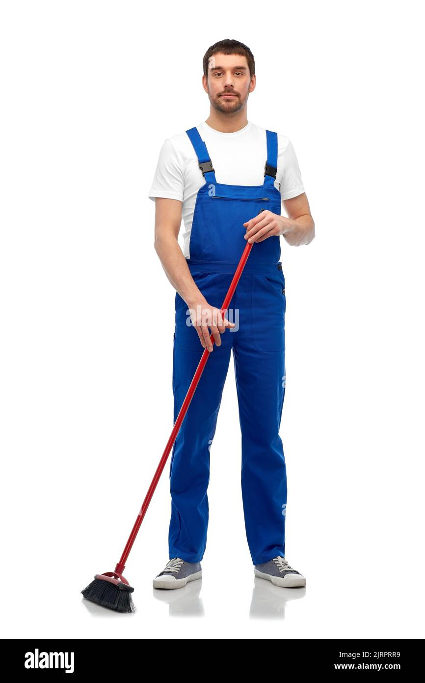 male cleaner in overall cleaning floor with broom Stock Photo - Alamy