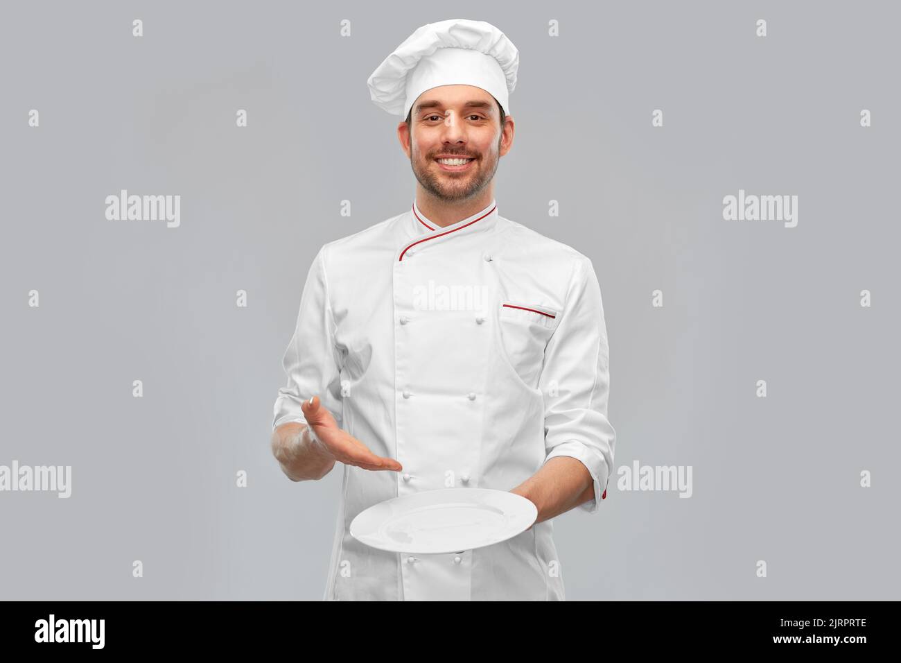 happy smiling male chef holding empty plate Stock Photo - Alamy