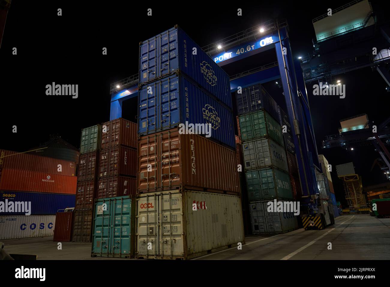 Operation of container terminal at night. Unloading container ship at ...
