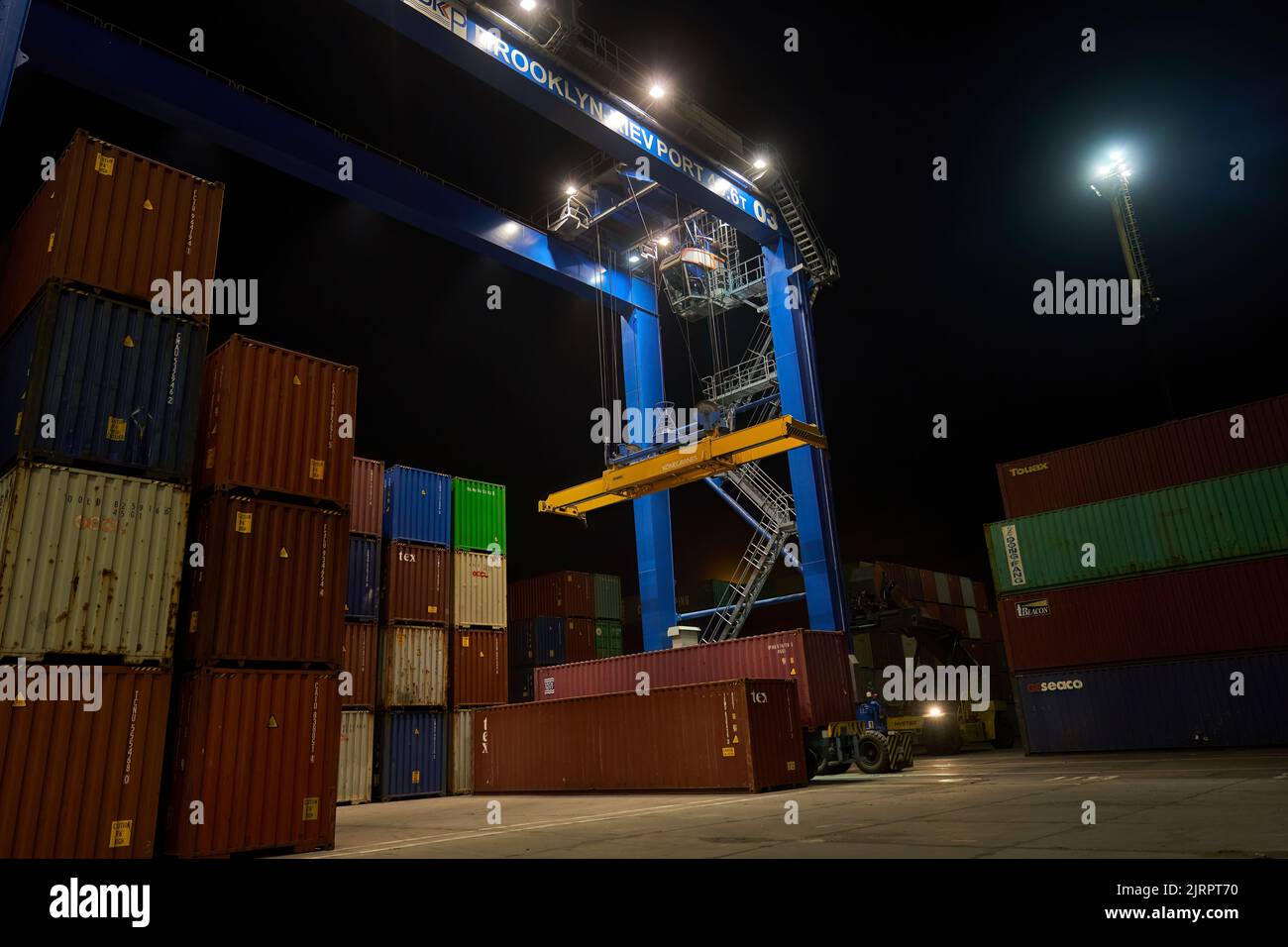 Operation of container terminal at night. Unloading container ship at ...