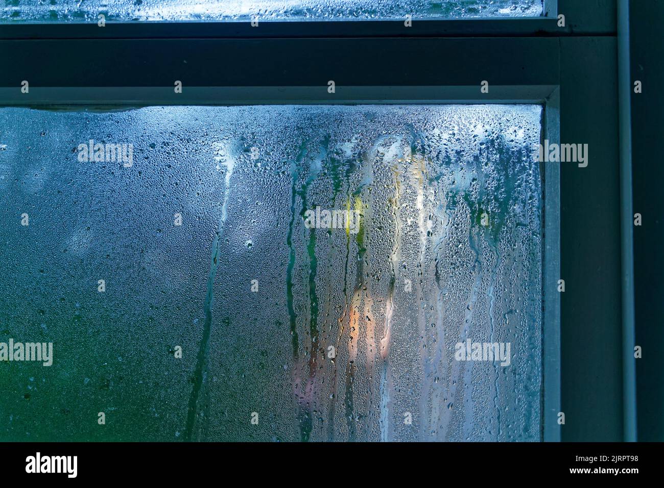Condensation on the inside of a single glazed window in a cold damp ...
