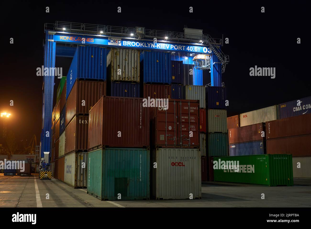 Operation of container terminal at night. Unloading container ship at ...
