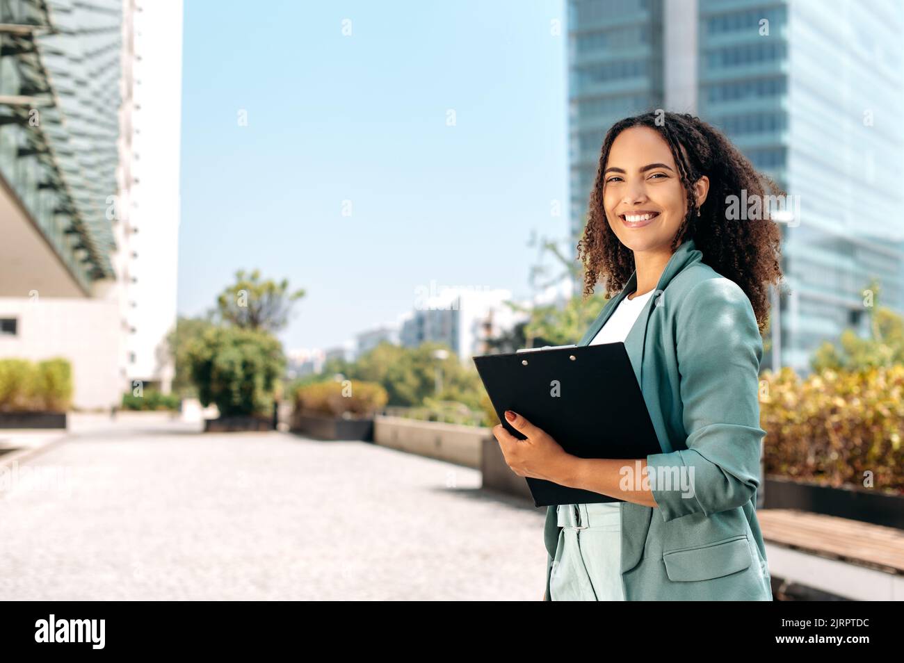 Successful positive confident young brazilian or hispanic curly haired ...