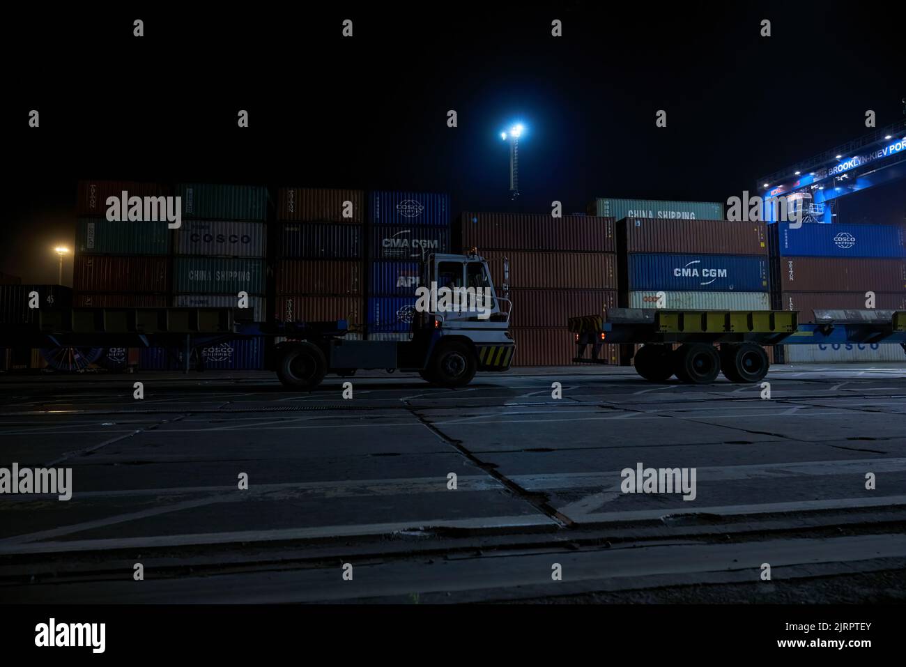 Operation of container terminal at night. Unloading container ship at ...
