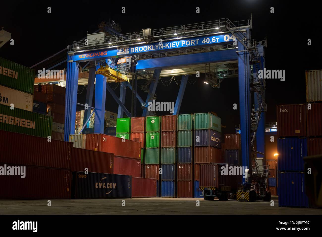 Operation of container terminal at night. Unloading container ship at ...