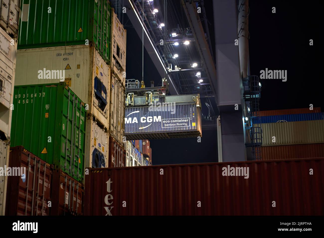 Operation of container terminal at night. Unloading container CMA CGM ...