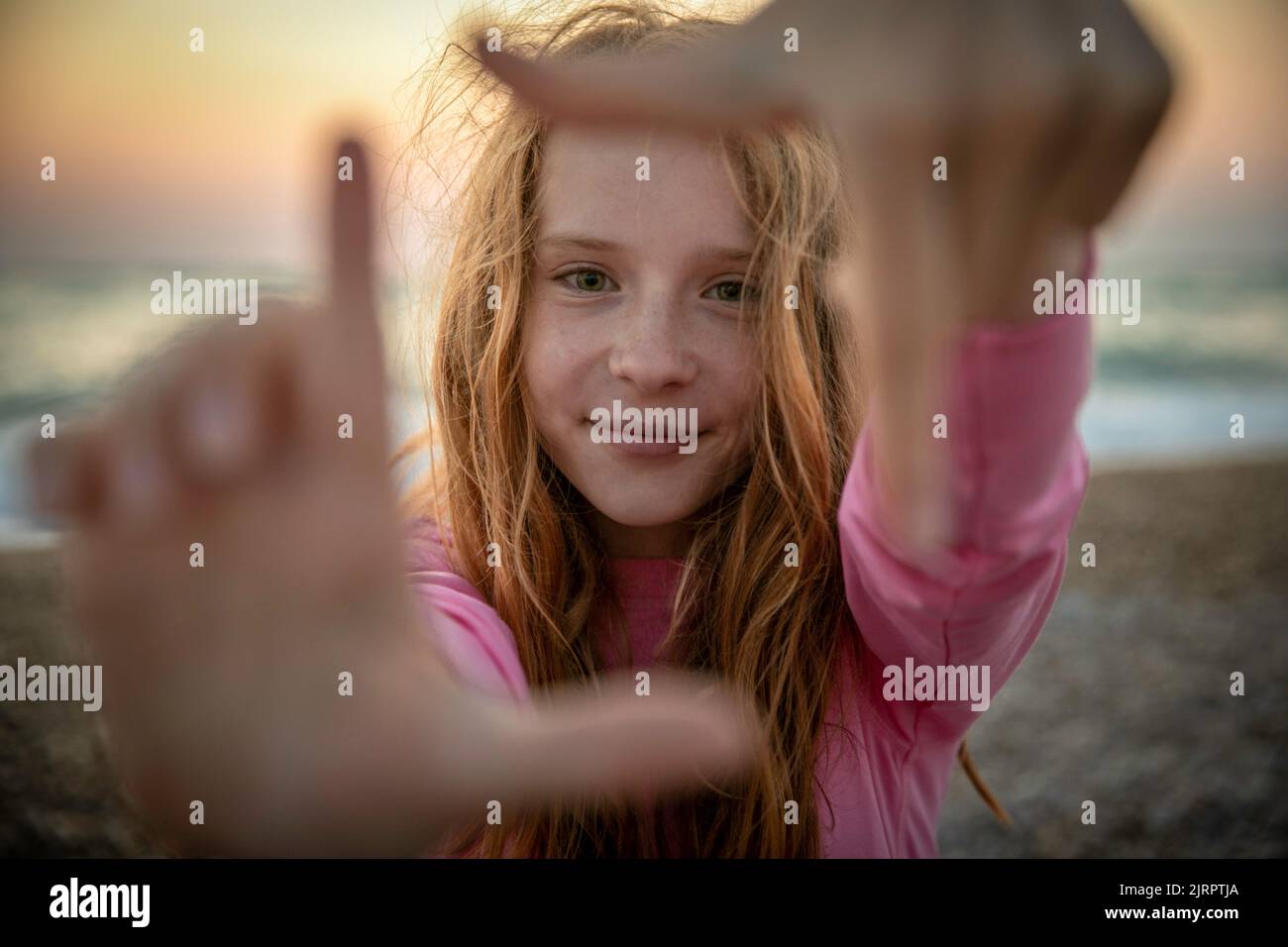 Portrait of a red-haired teenage girl with hands Stock Photo - Alamy