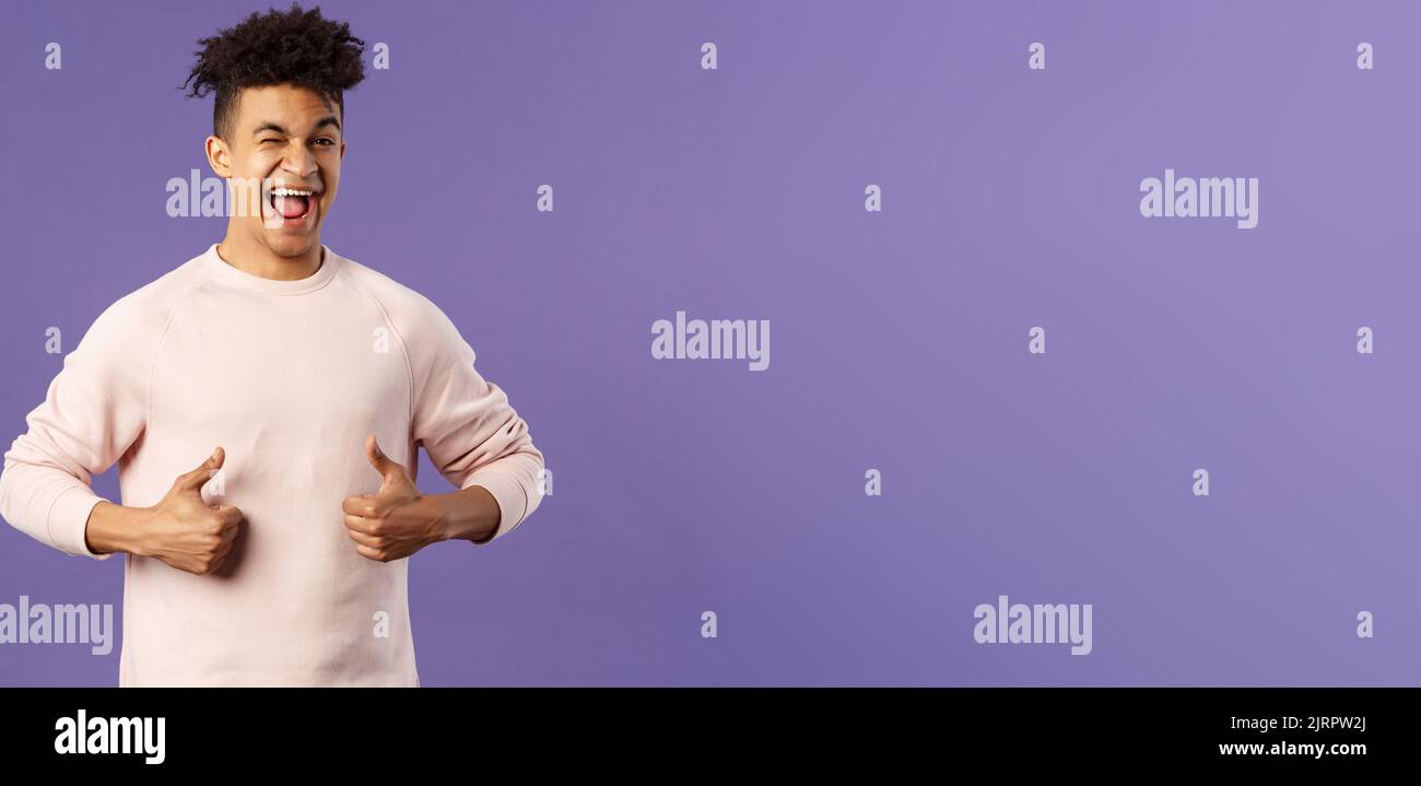 Portrait of enthusiastic lively, attractive young guy winking encourage ...