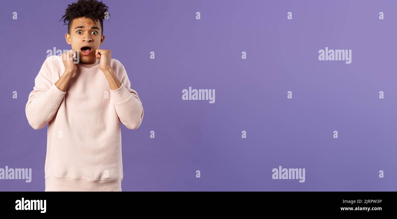 Portrait of scared hispanic guy screaming from fright, hold hands near ...