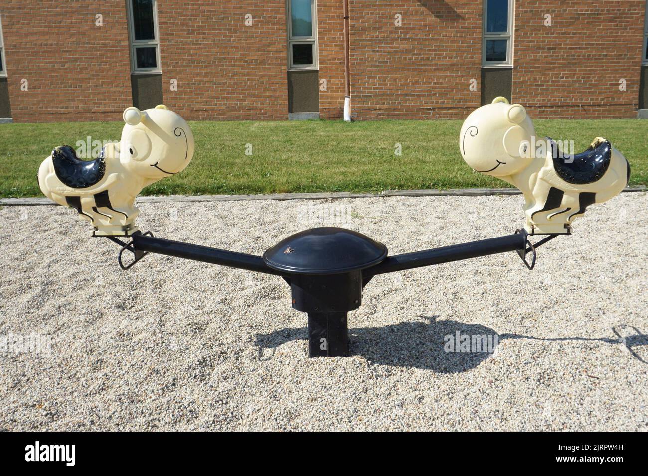 Vintage smiling bee playground ride at a grade school Stock Photo - Alamy