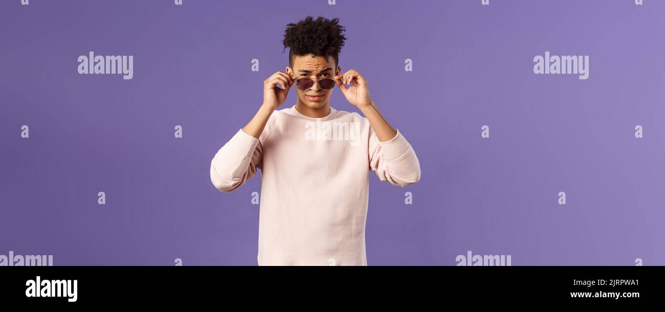 Portrait of sassy and confident young judgemental man, taking-off ...