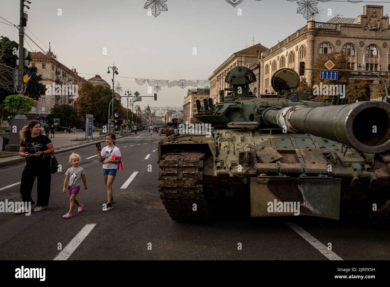 Mother and her daughters walk past the wreckage of destroyed Russian ...