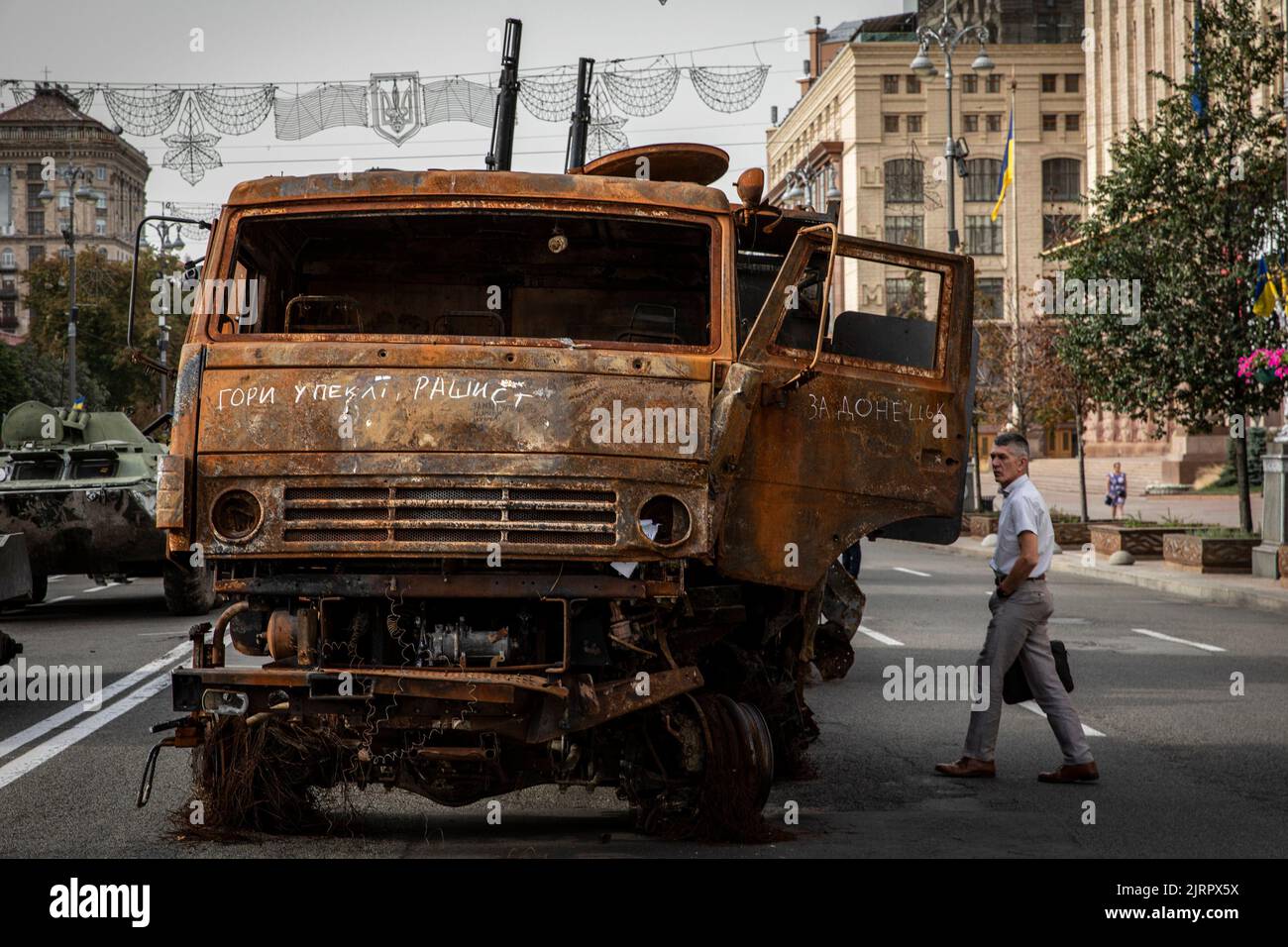 An office worker with his bag observes the wreckage of a Russian ...