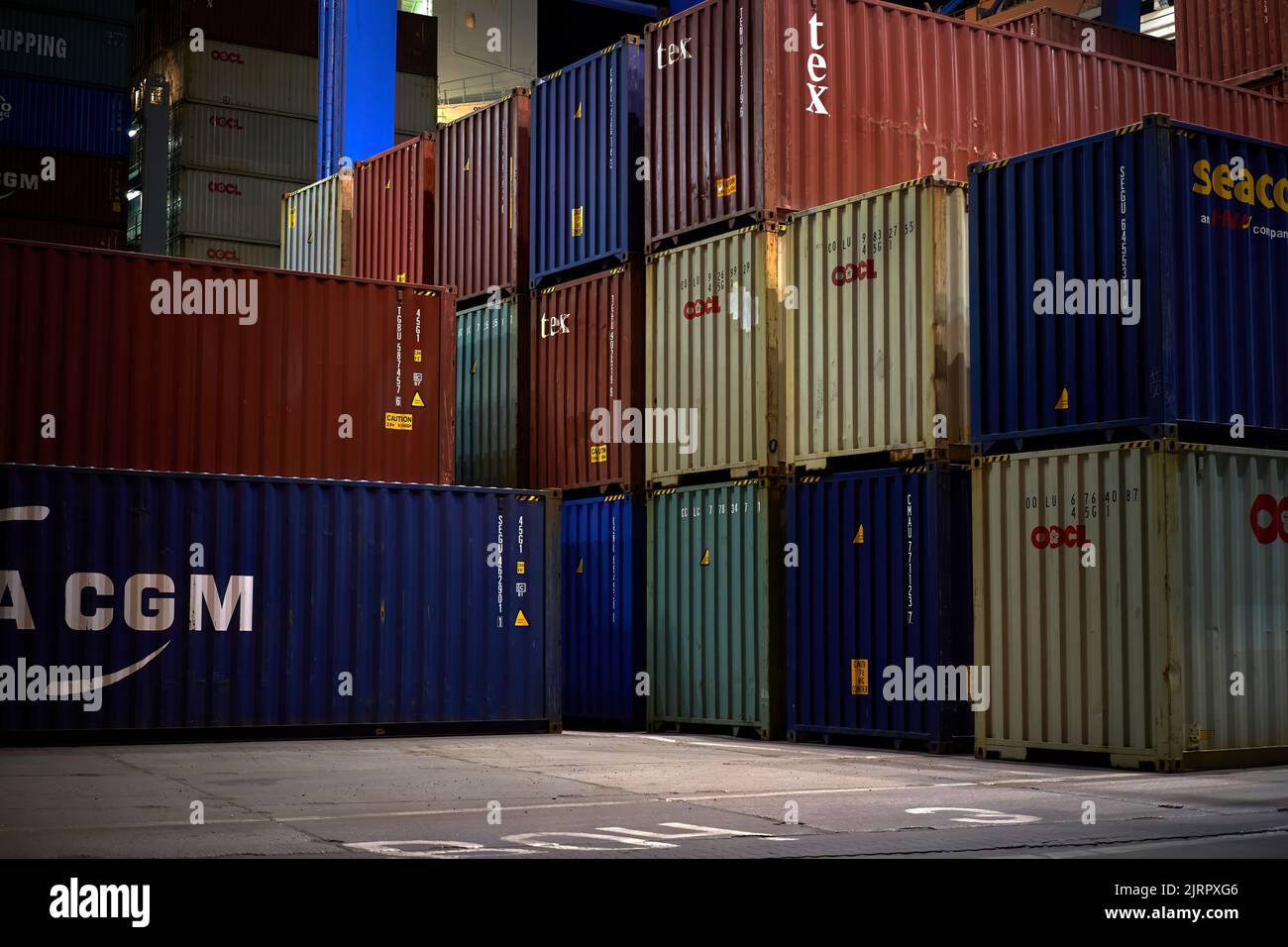 Operation of container terminal at night. Unloading container ship at ...