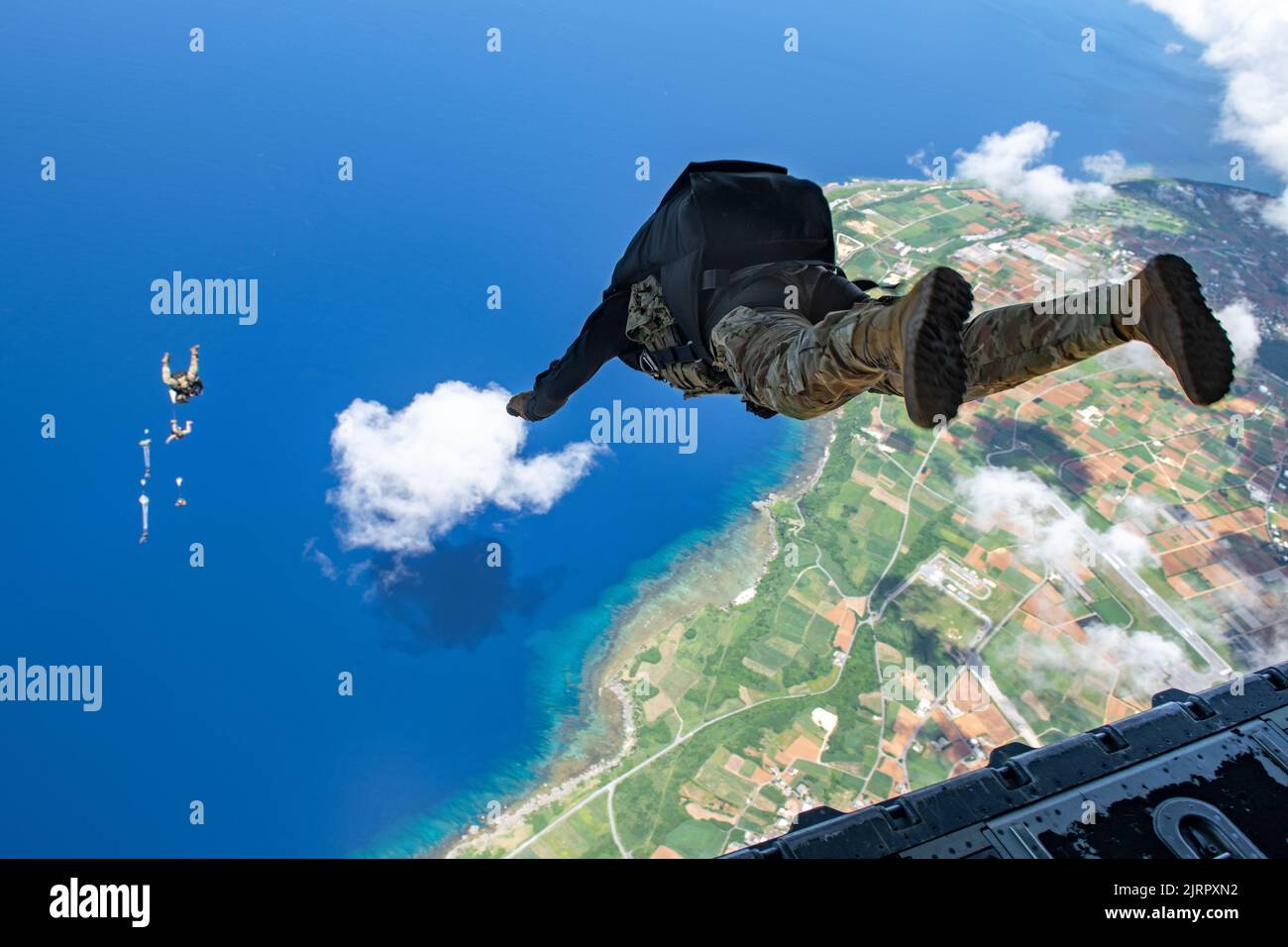 A U.S. Navy sailor jumps out the door of a 1st Special Operations ...