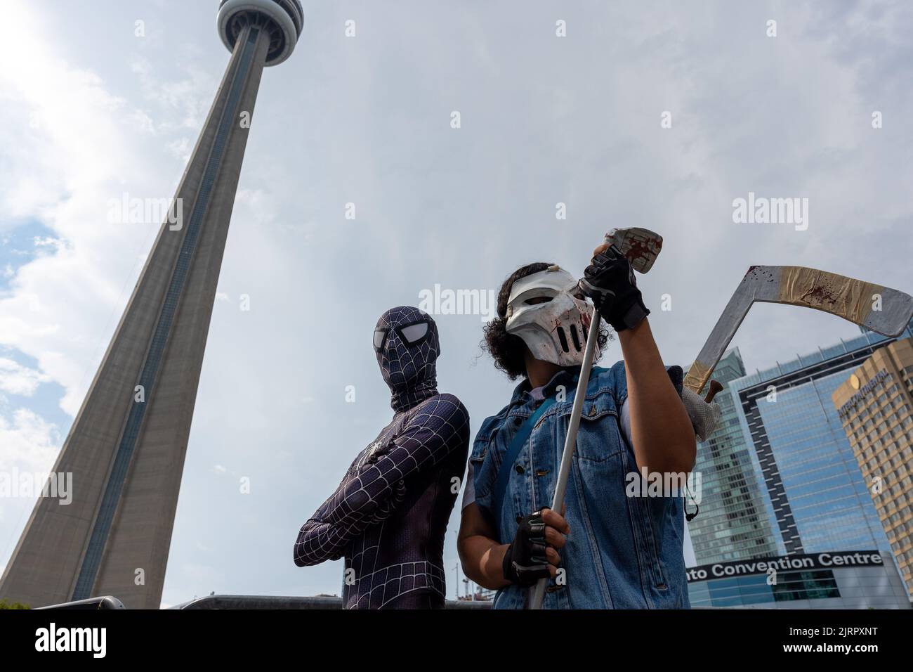 People in costumes pose outside the Metro Toronto Convention Centre ...