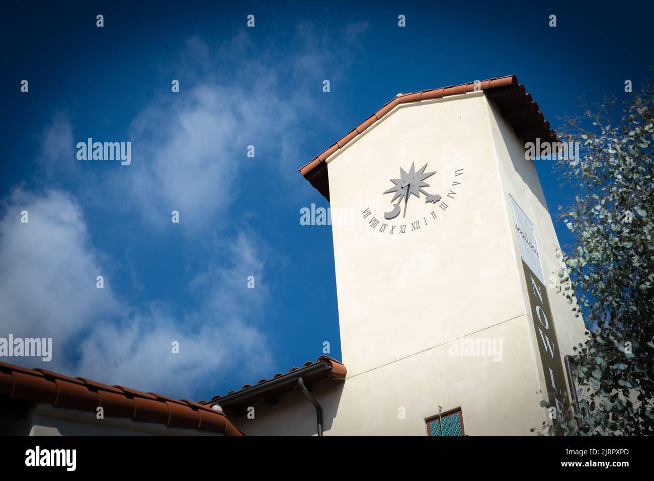 Spanish building with sun dial clock Stock Photo - Alamy