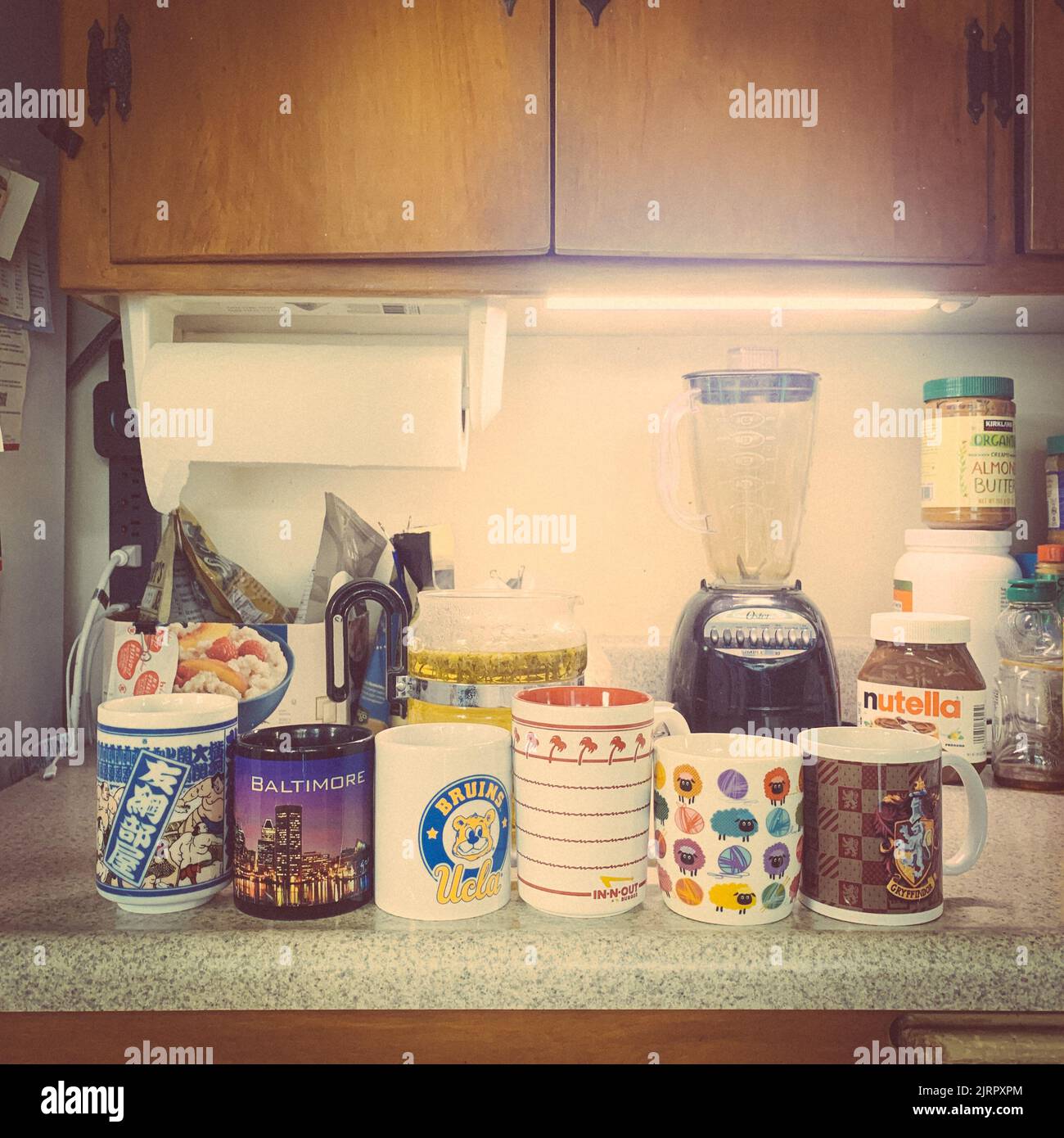 Morning coffee with family mugs lined up on kitchen counter Stock Photo ...