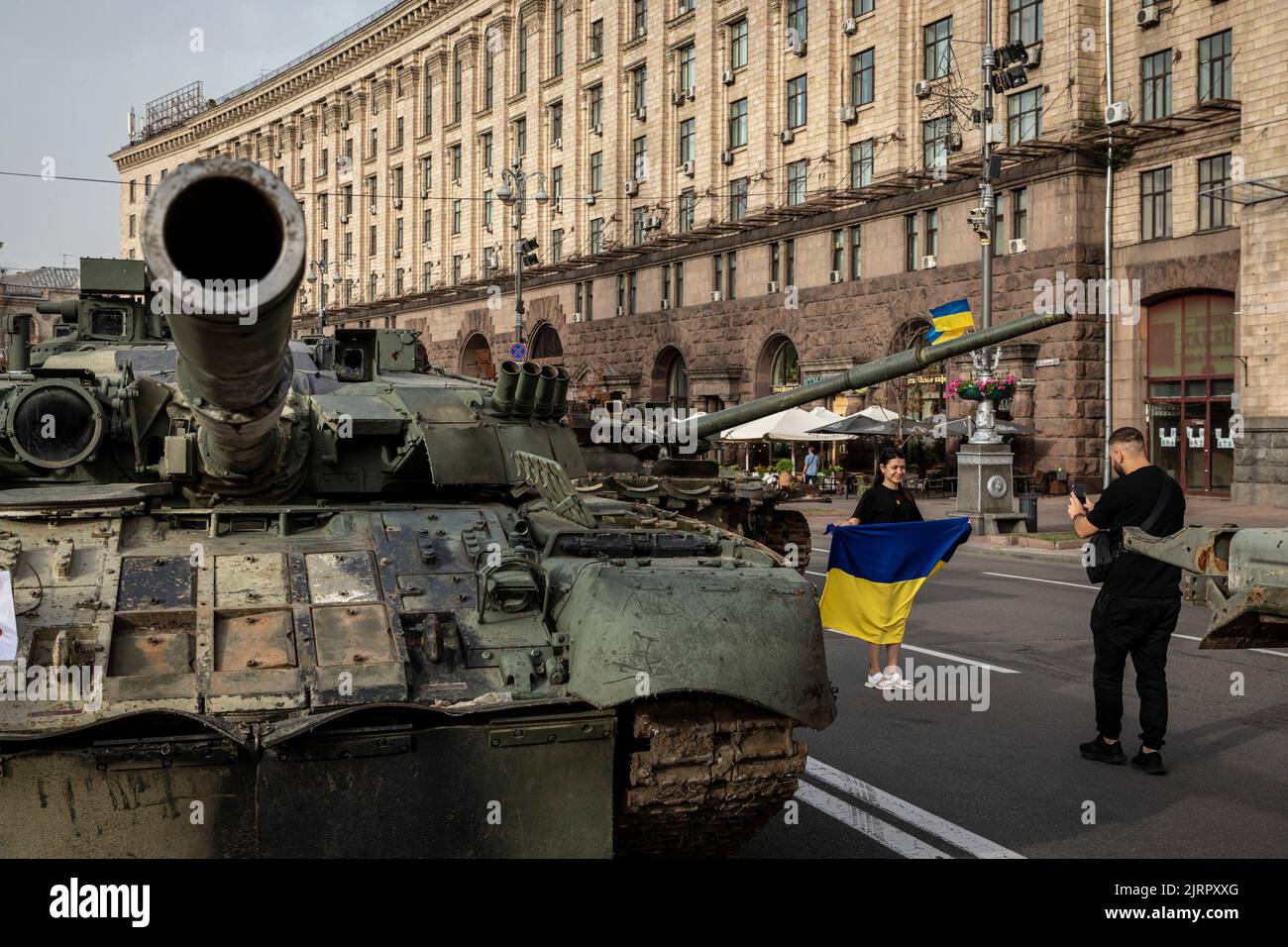 Illya (L2) and his girlfriend Anastasia (L1) take photos with the ...