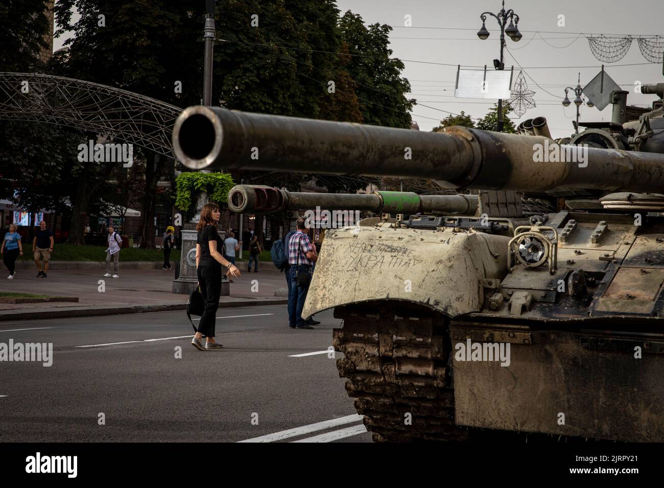 A woman observes the wreckage of a destroyed Russian artillery in Kyiv ...