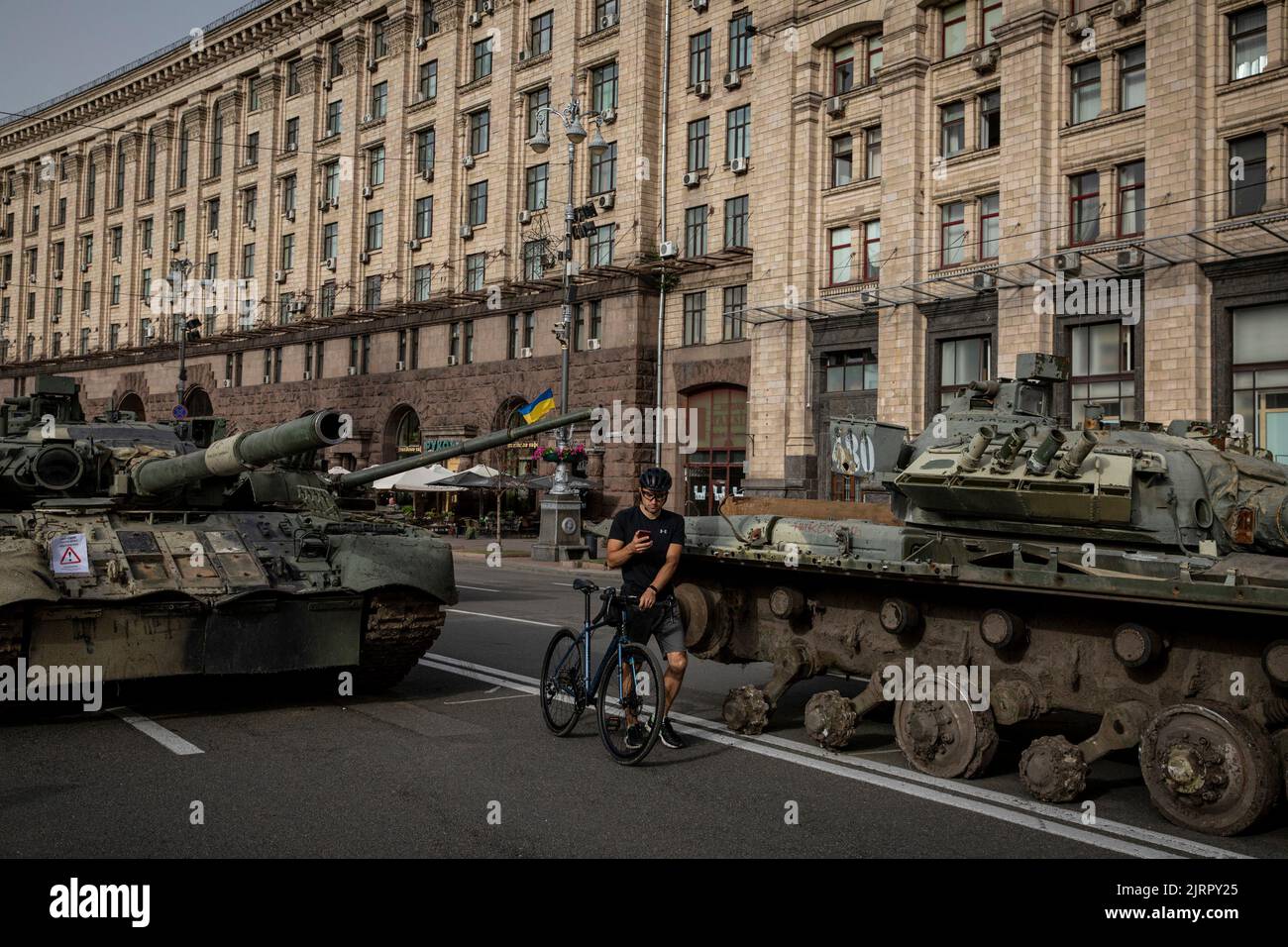 A man with a bicycle walks through the wreckage of destroyed Russian ...